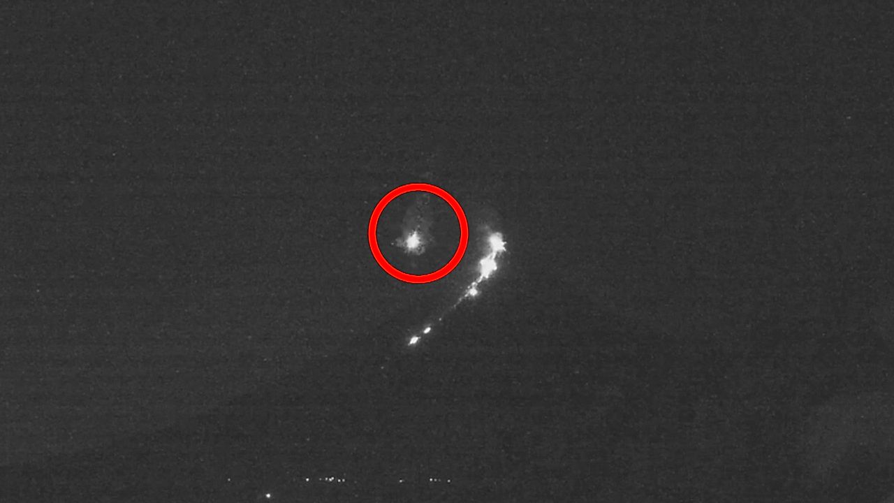 Meteor streaks across erupting Mayon Volcano in stunning night sky footage