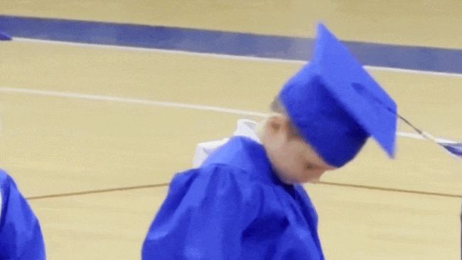 Boy's bored reactions steal the show at kindergarten graduation
