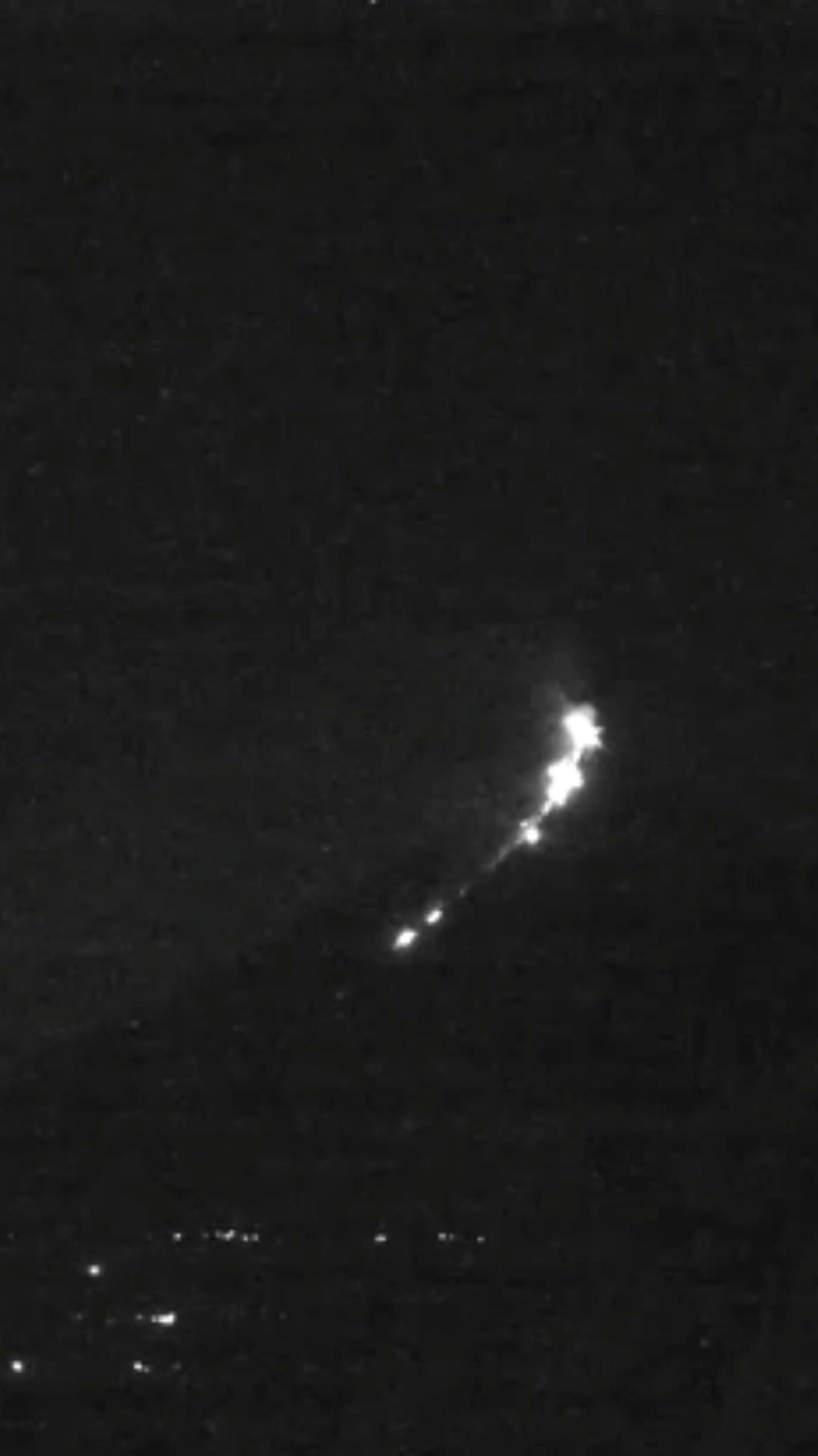 Social moment meteor flies through sky beside erupting volcano