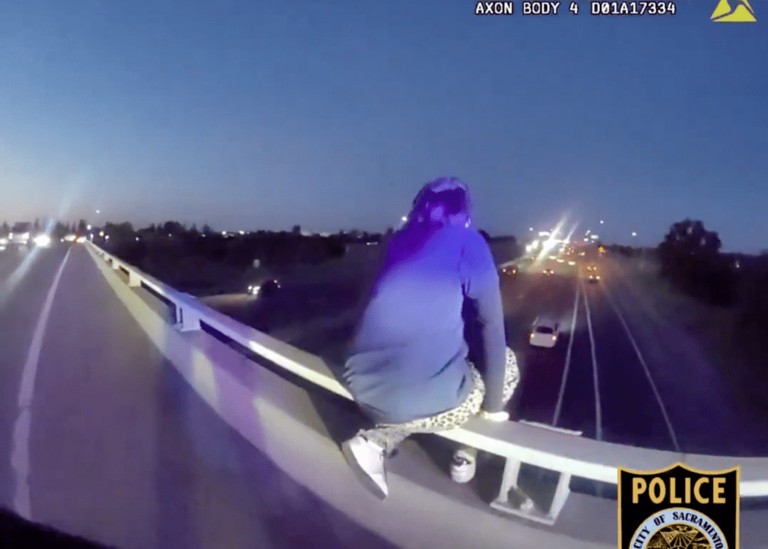 Heart-stopping moment cops rescue sobbing kid dangling dangerously from ...