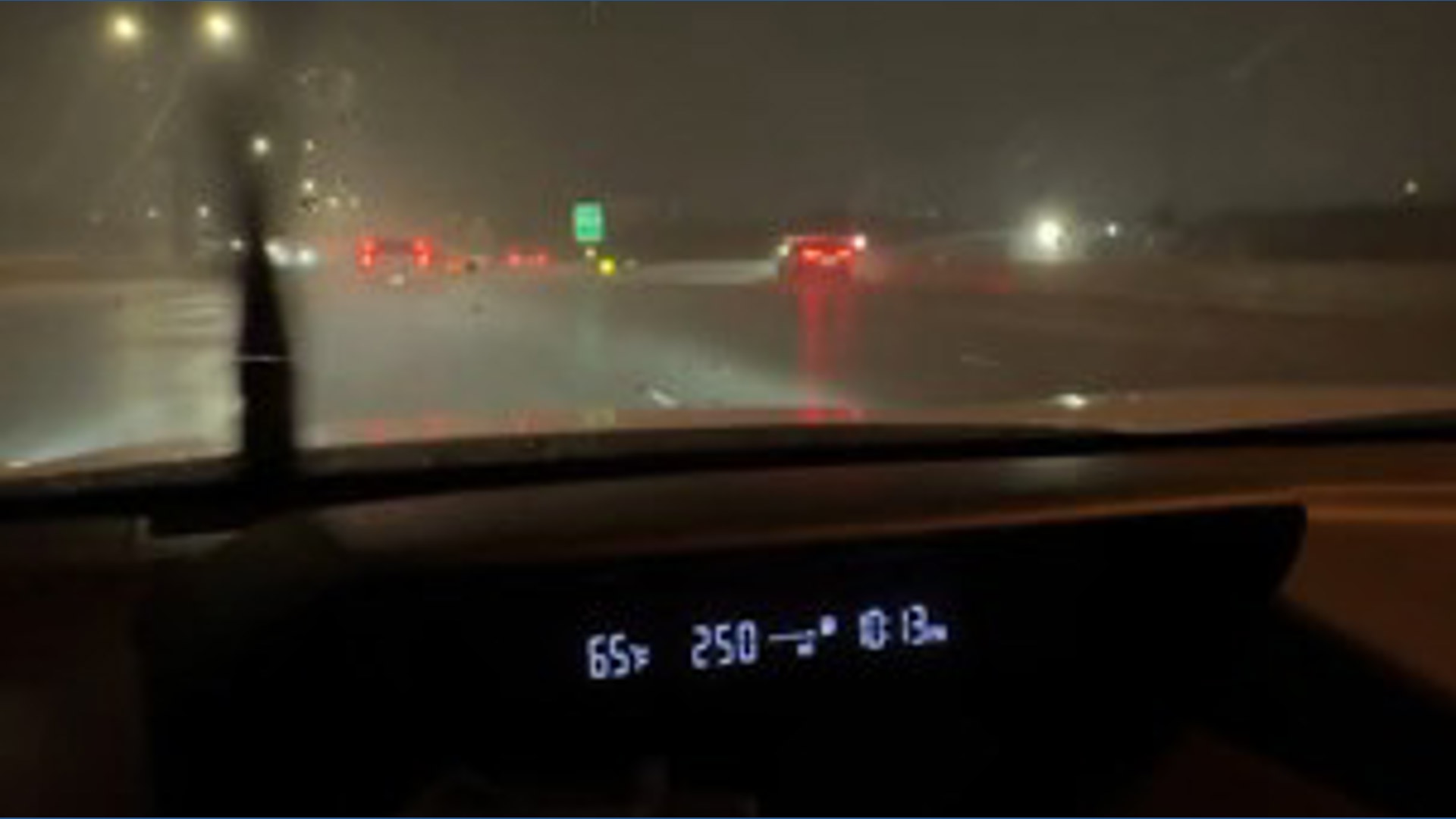 Heavy rain and lightning flashes during thunderstorm on I-10 West