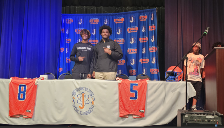 Johnson celebrates 2 football players headed to next level