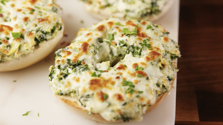 Repurpose leftover spinach and artichoke dip into a bagel topping