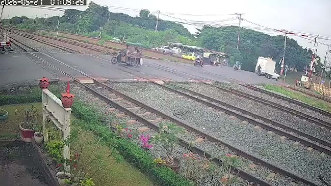 School van caught on railway tracks as train approaches