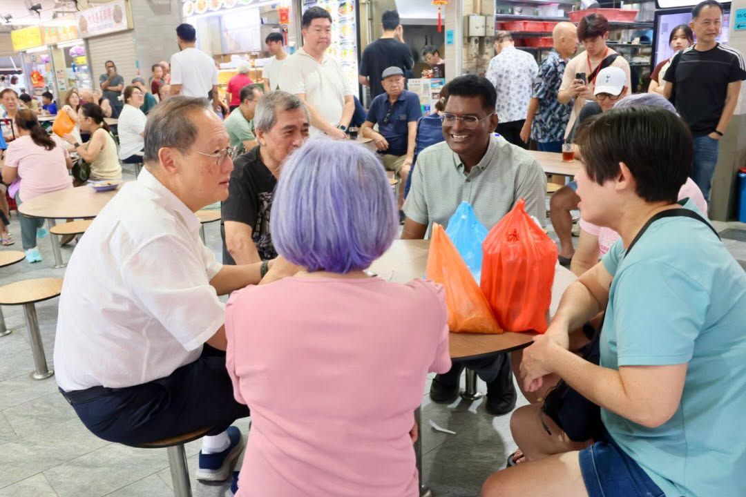 Pritam Singh greets Tan See Leng, grassroots adviser, at Eunos hawker ...