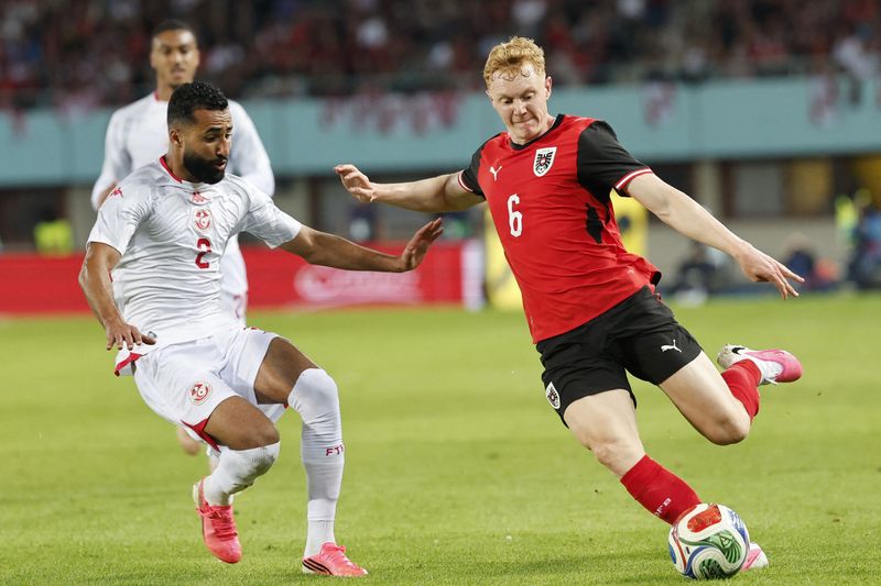 Soccer-Austria fight back from early red card to beat Tunisia