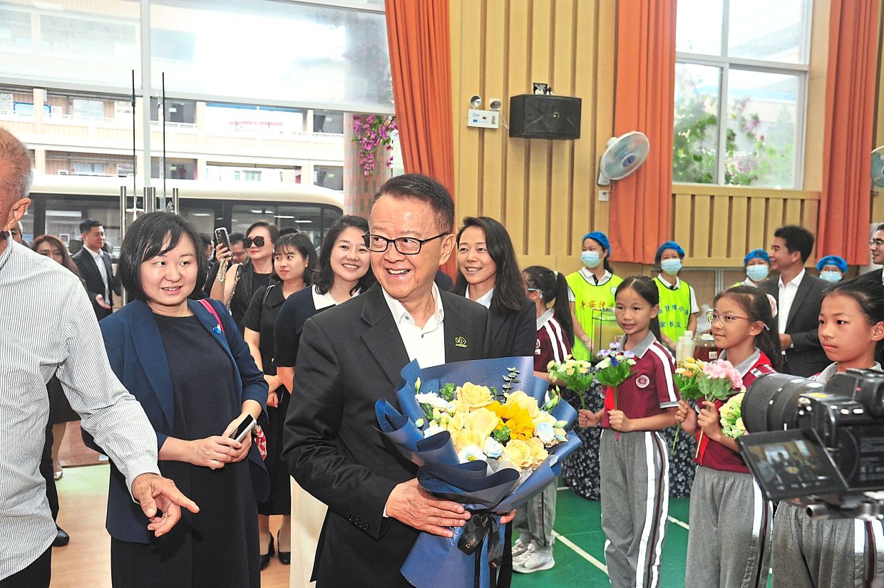 Conglomerate founder makes memorable visit to ancestral village