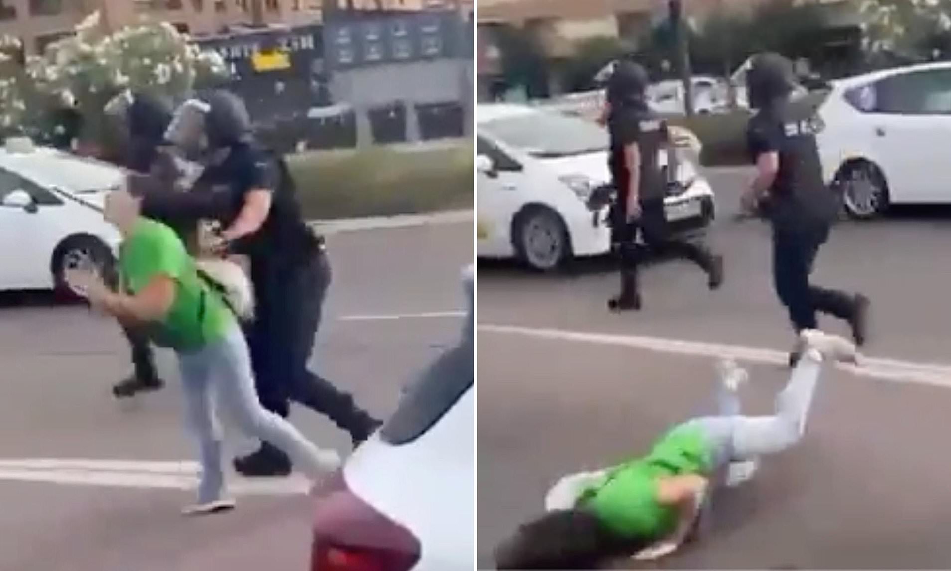 Moment riot police officer shoves protester to the ground from behind ...