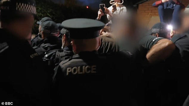 Moment police drag paedophile from his home to protect him from baying ...