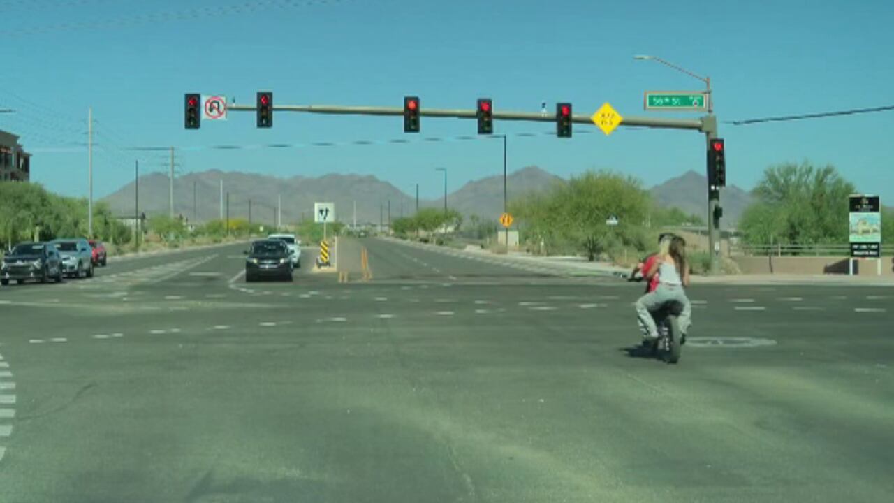 North Phoenix e-bike riders nearly hit by car after running red light