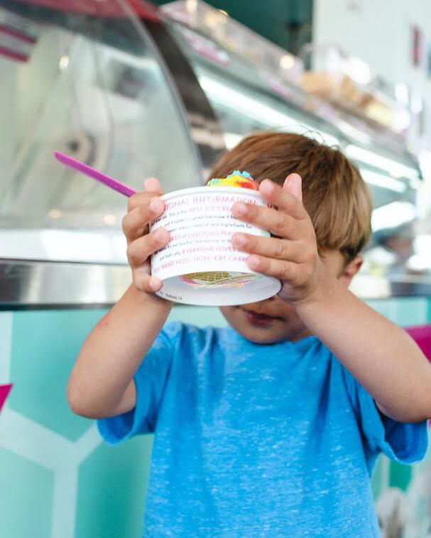 Chocolate Shoppe Ice Cream placing prize-winning golden stickers under ...