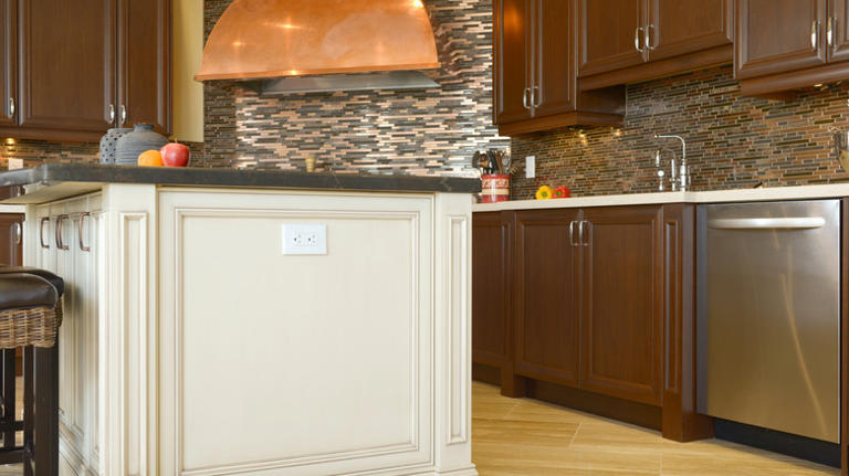 Why are side-mounted outlets no longer allowed on kitchen islands?
