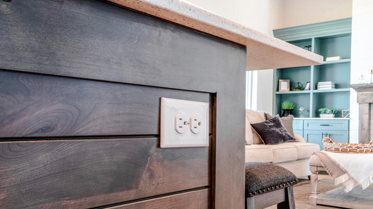 Why are side-mounted outlets no longer allowed on kitchen islands?