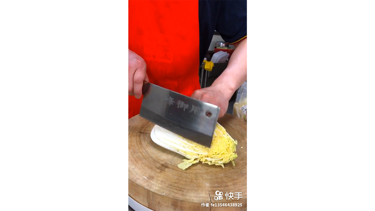 Shredding napa cabbage into thin strips with sharp cleaver creating ...