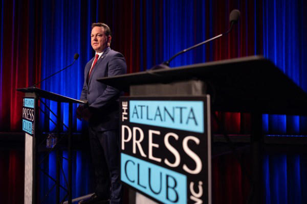 Burt Jones takes shots at absent rival on the debate stage as Rick ...