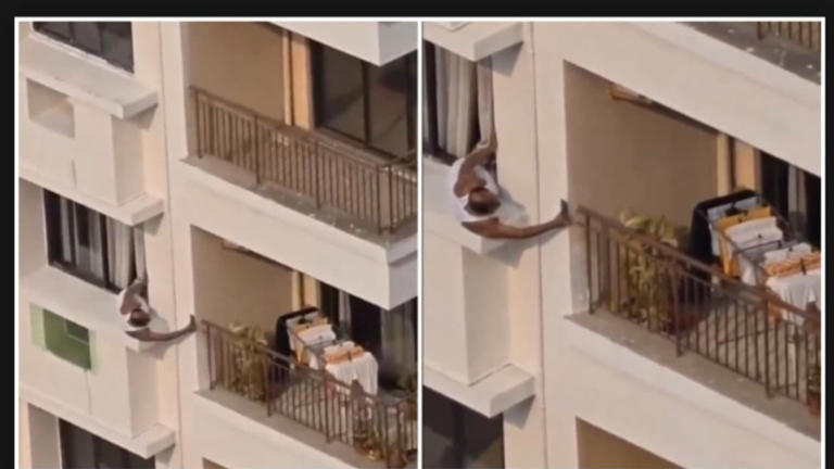 Elderly man leans out of high-rise balcony to record neighbour's flat ...