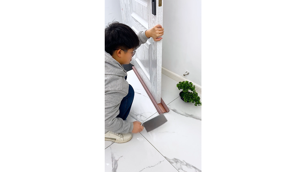 Installing door bottom seal strip to block drafts resulting in better ...