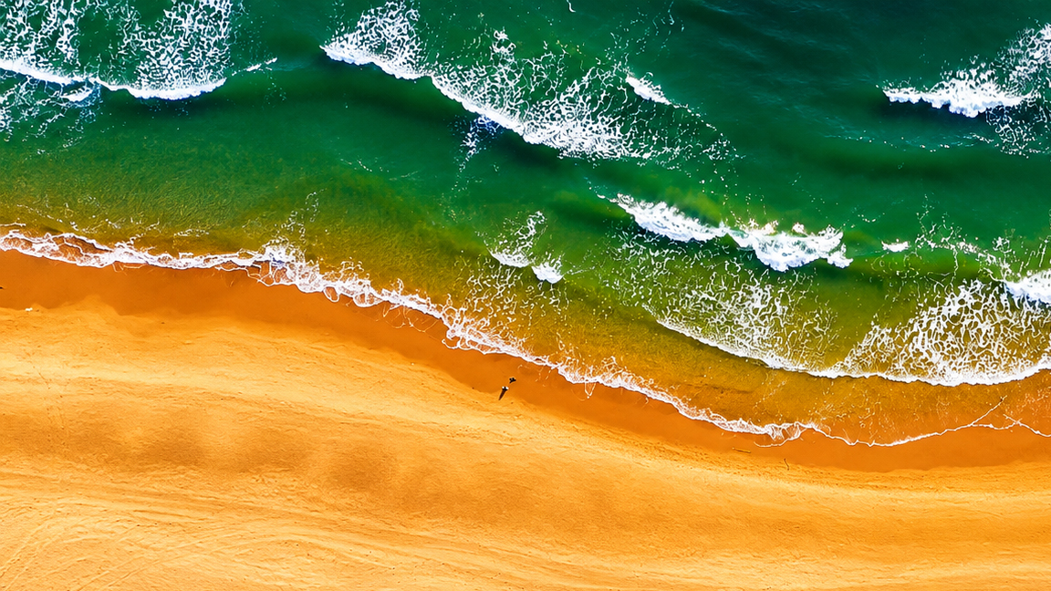 Tropical coastline with crystal waves and golden sand