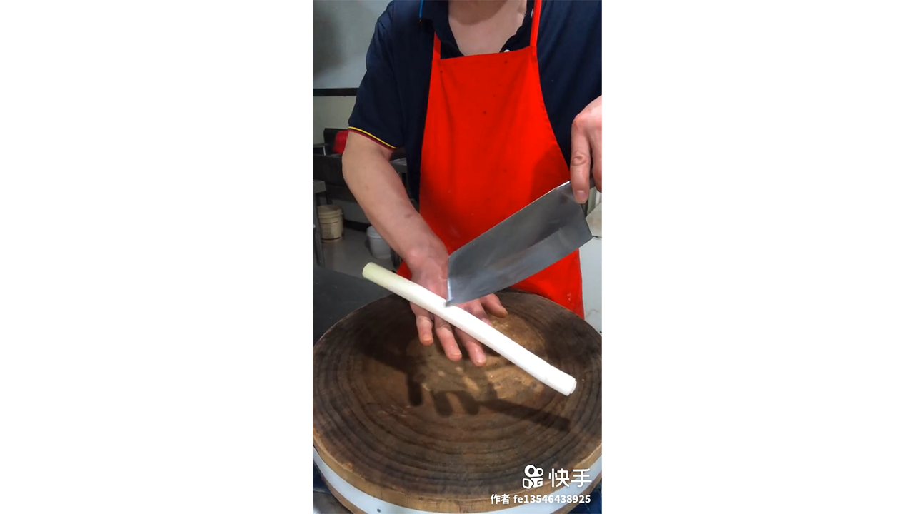 Slicing fresh leek with sharp cleaver creating clean and even cuts