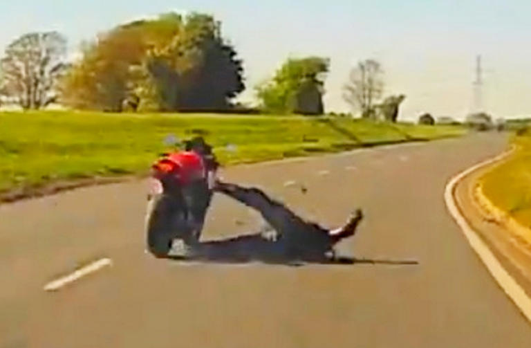 Motorcyclist thrown from bike, narrowly avoiding oncoming traffic