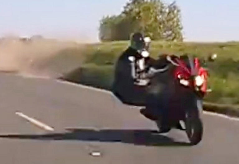 Motorcyclist thrown from bike, narrowly avoiding oncoming traffic