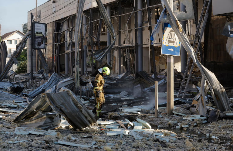 Residents trapped under rubble after Russian missile barrage on Kyiv