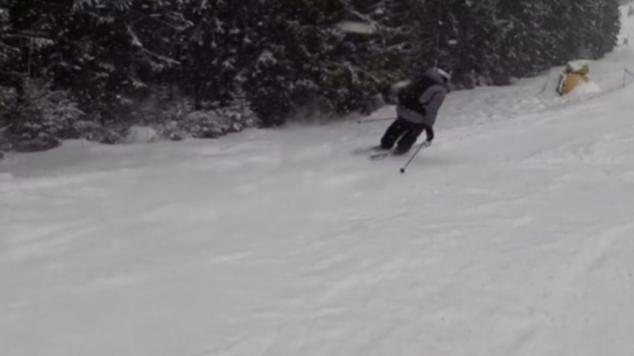 Skier slips and falls after trying to stay balanced on slick ice