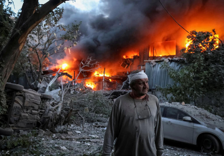 Residents trapped under rubble after Russian missile barrage on Kyiv