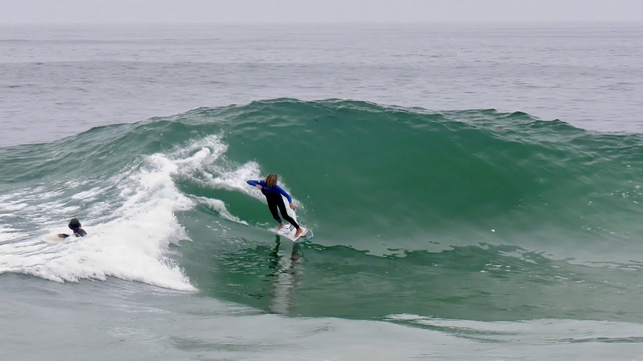 Professionals attempt to ride wooden skimboard at The Wedge