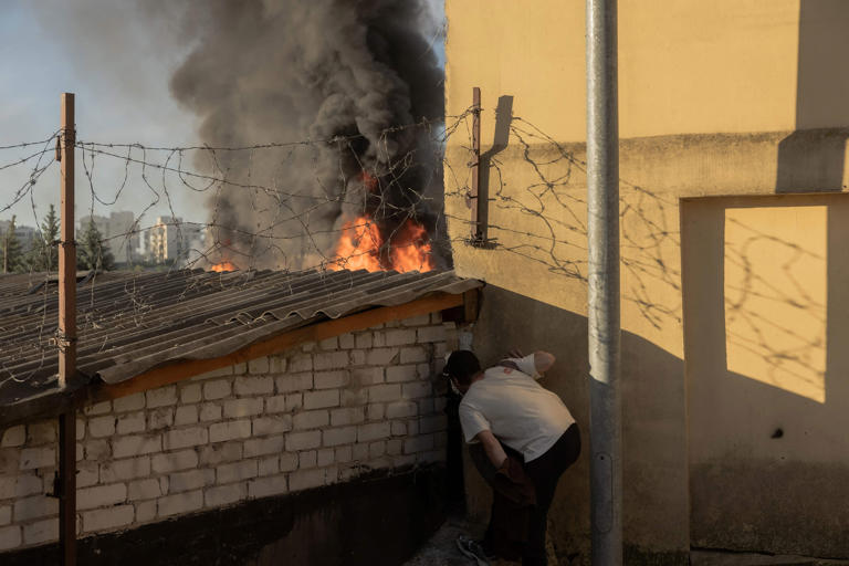 Residents trapped under rubble after Russian missile barrage on Kyiv