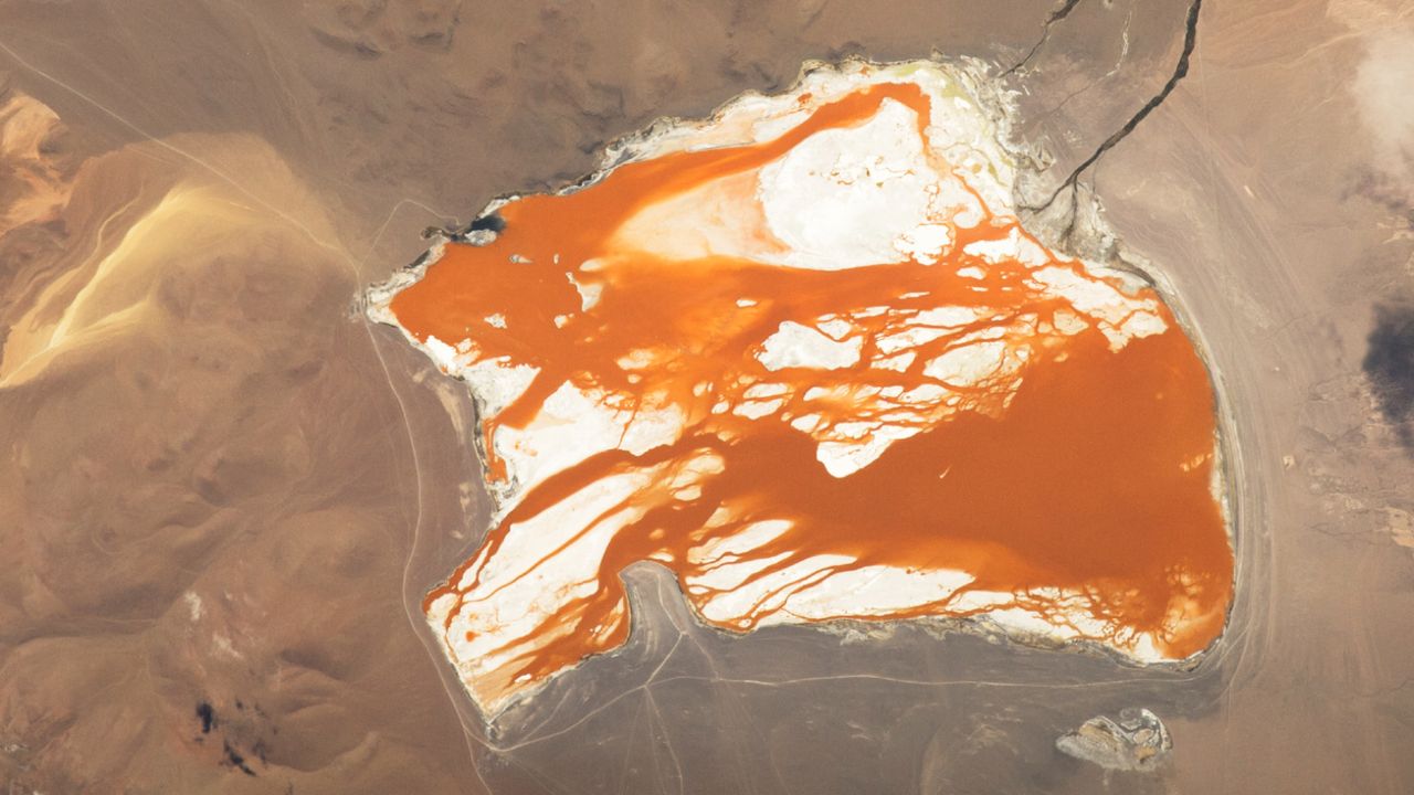 Rusty, orange water 'bleeds' across brilliant Bolivian lagoon — Earth ...