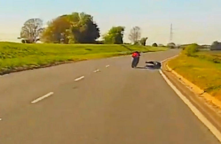 Motorcyclist thrown from bike narrowly avoiding oncoming traffic