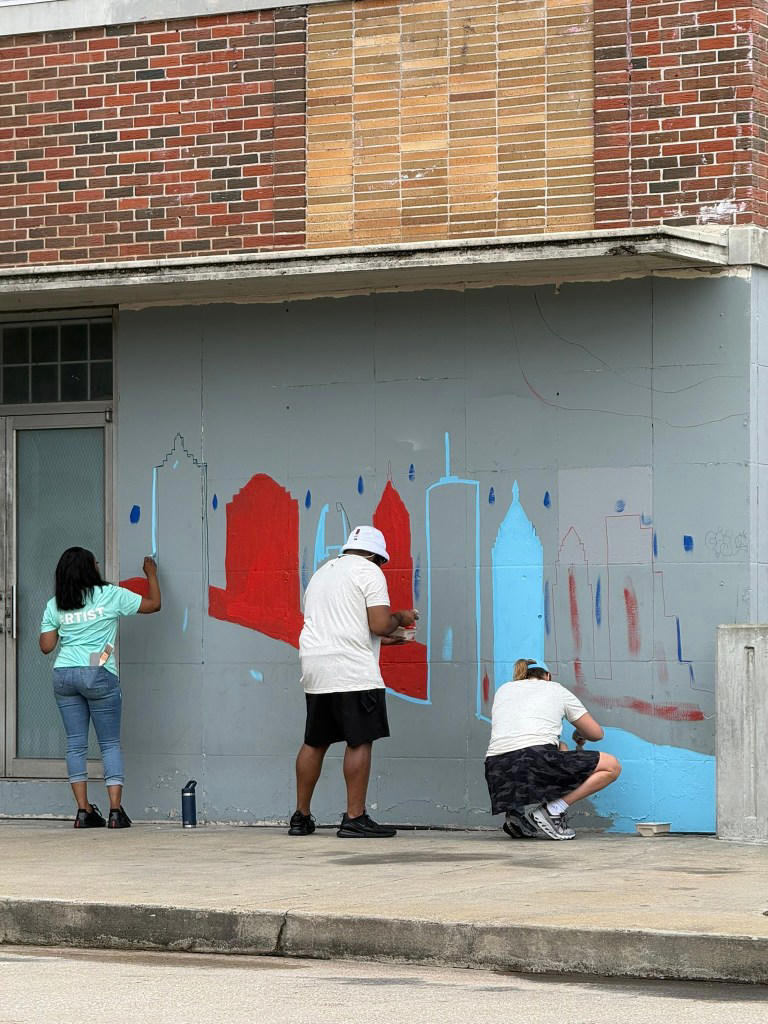 Volunteers work to beautify downtown Atlanta ahead of FIFA World Cup