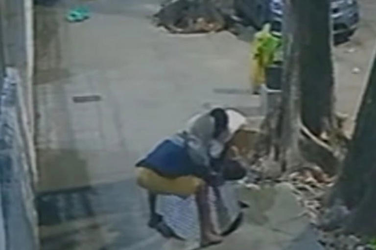 Woman rushed to hospital after falling down manhole when men 'tried to ...