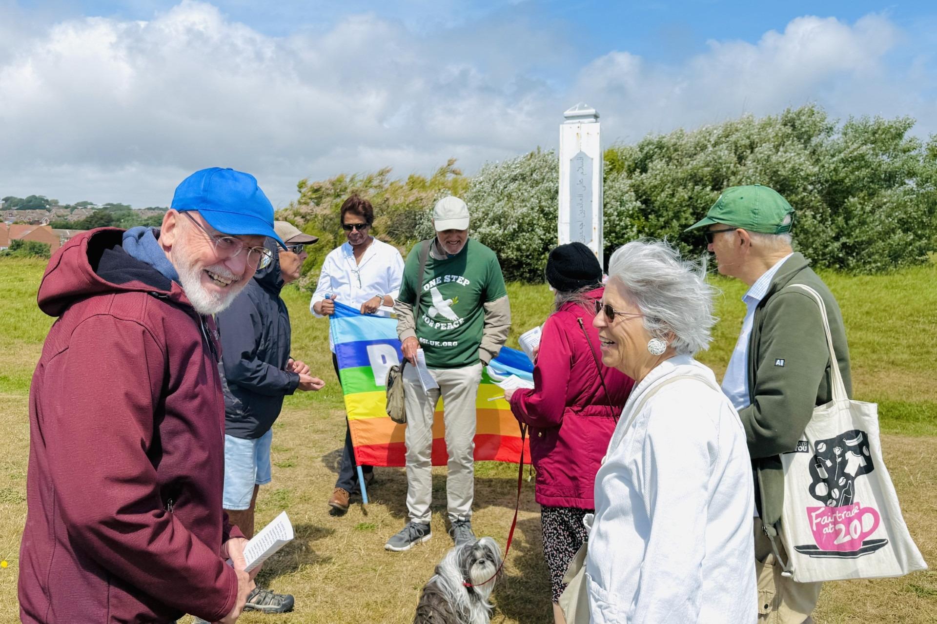 Community gathering at the Bexhill Peace Pole