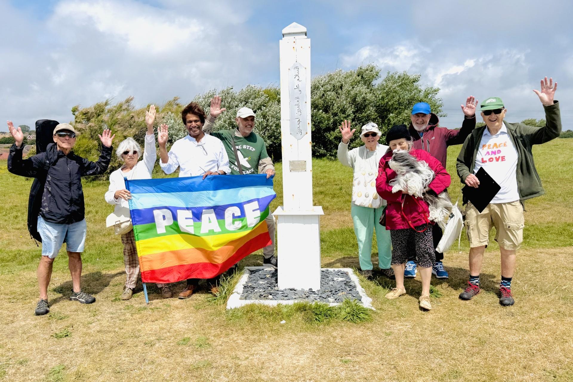 Community gathering at the Bexhill Peace Pole