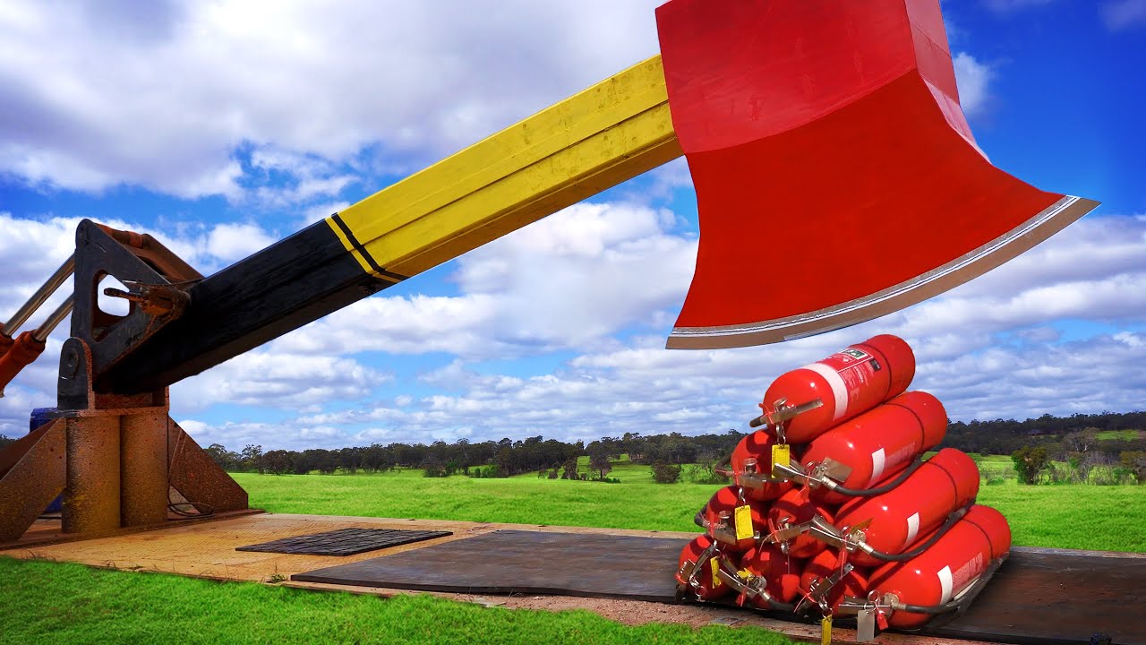 Watch what happens when a giant axe hits 10 fire extinguishers