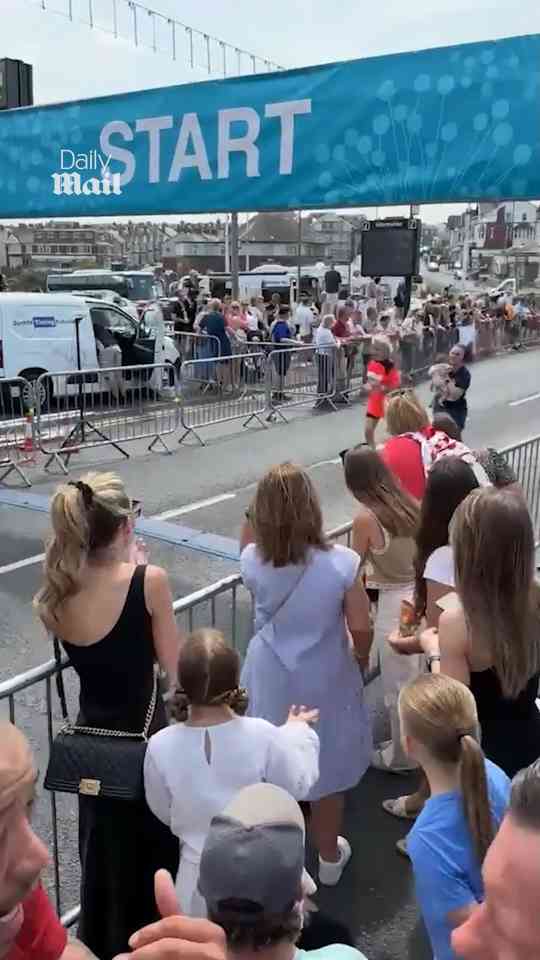 Proud mom carries baby across 10K finish line in heartwarming moment