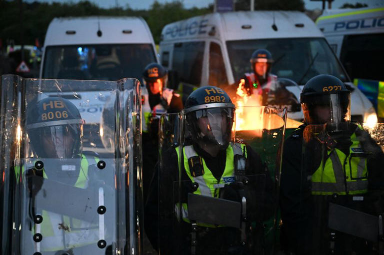 Officers under attack as flares and flaming wheelie bins pelted in ...