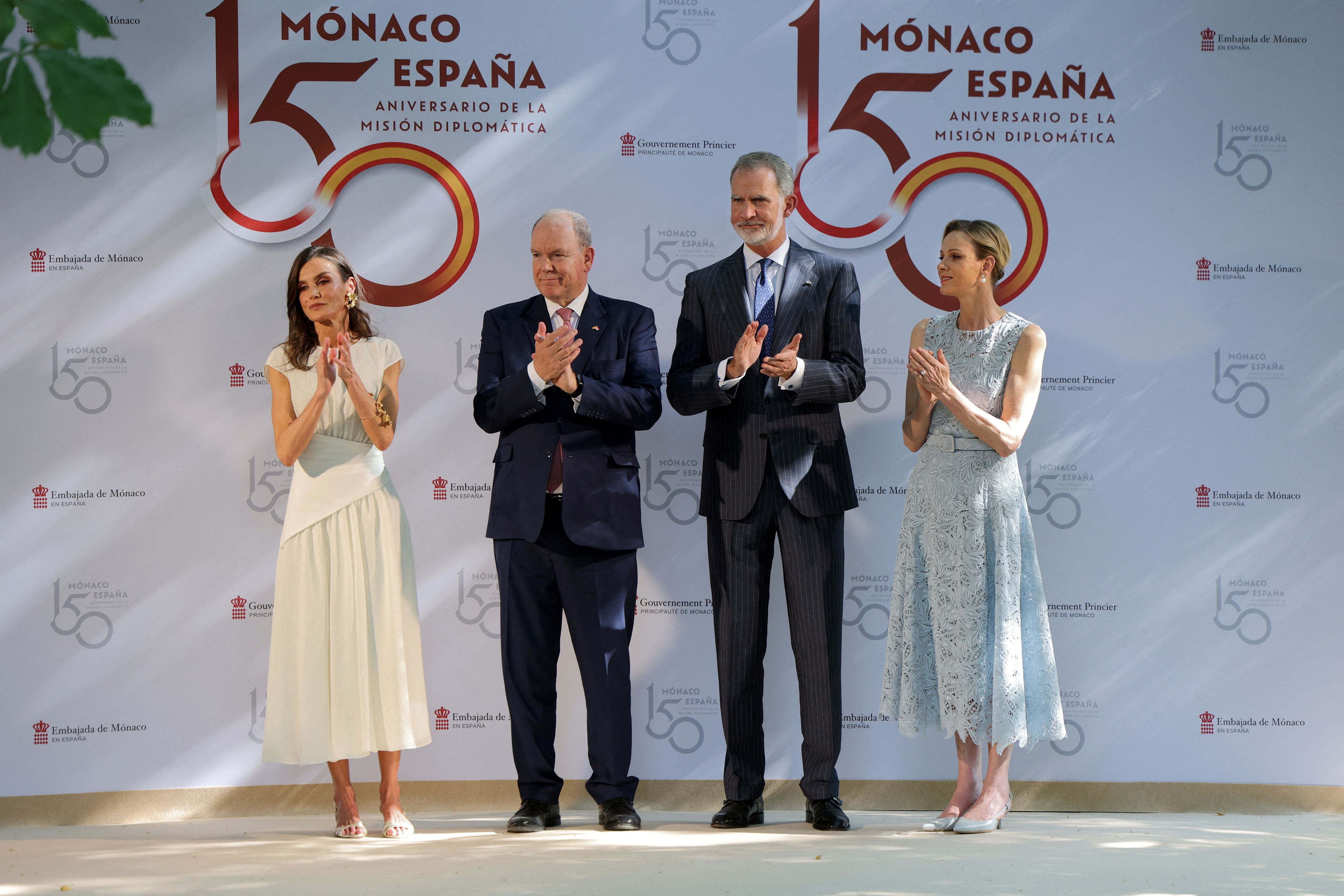 Queen Letizia adds an edgy arm cuff to her little white dress as she ...