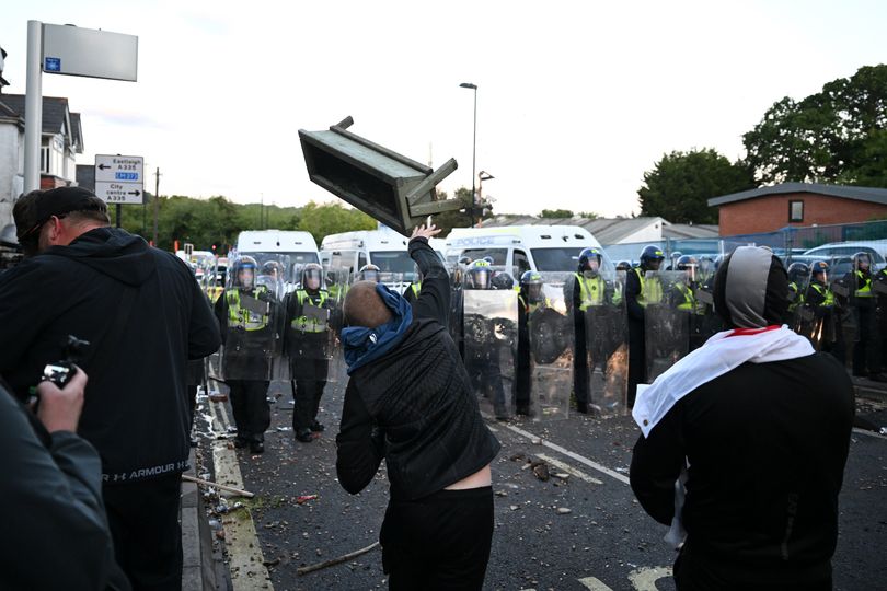 Officers under attack as flares and flaming wheelie bins pelted in ...