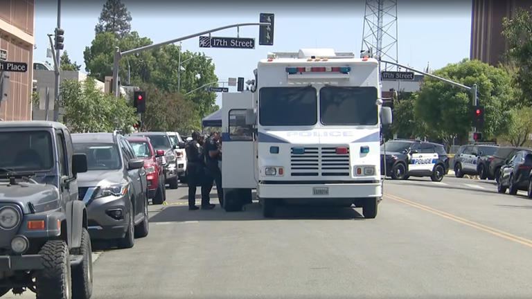 2 hostages released amid standoff after bomb threat reported at bank ...