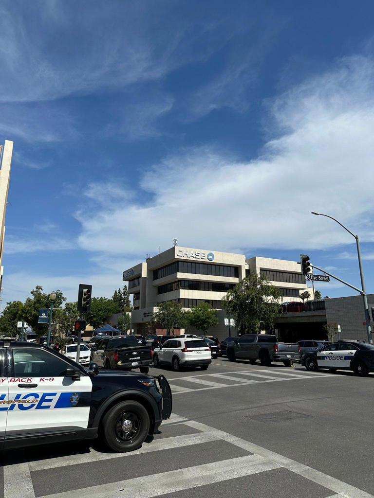 Suspect who held 10 people hostage at bank building fatally shot by FBI