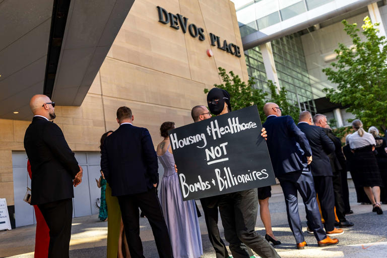 Dozens protest outside DeVos Place during Economic Club event featuring ...