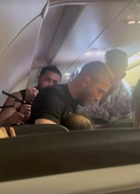 MMA fighter steps in as passenger tries to open plane door on Frontier ...