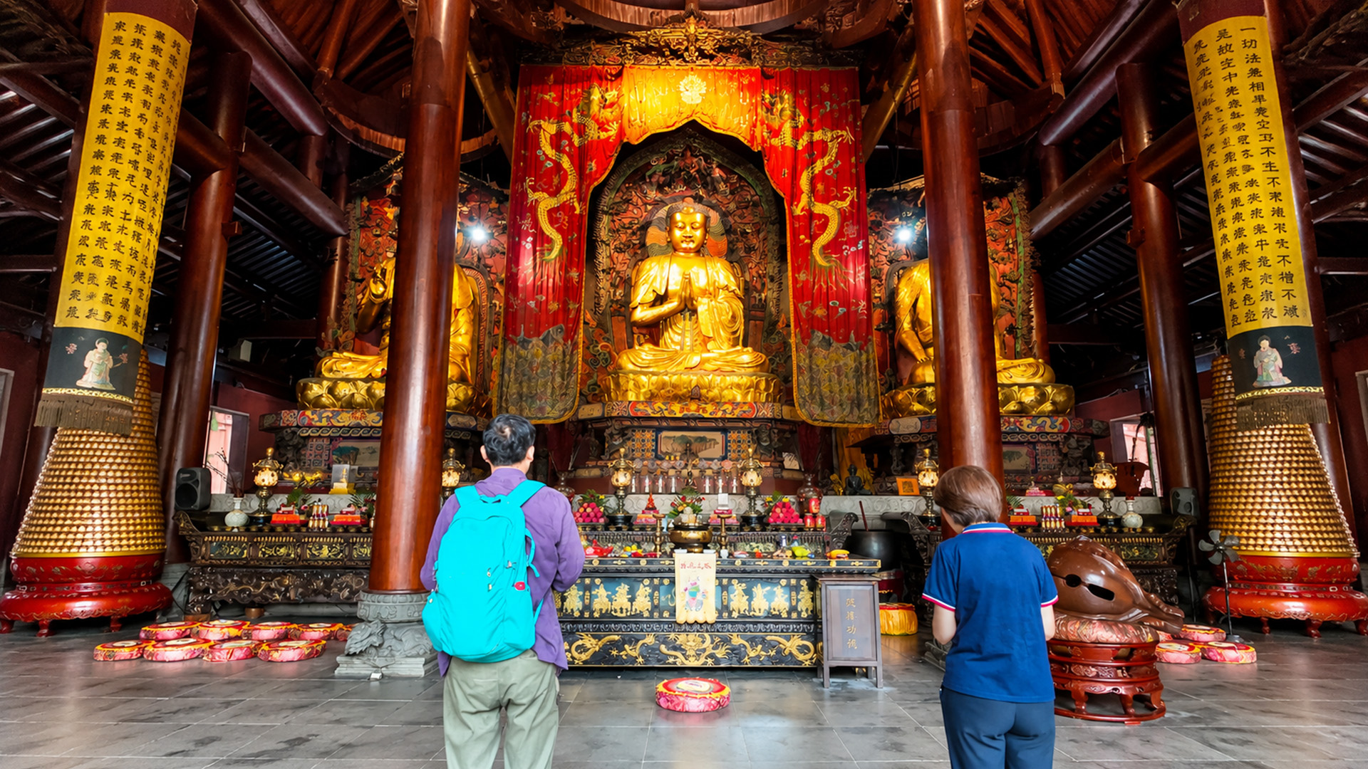 Inside a magnificent temple filled with golden Buddhist treasures