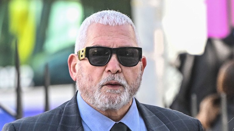 Mick Gatto and wife released from custody after police raid home