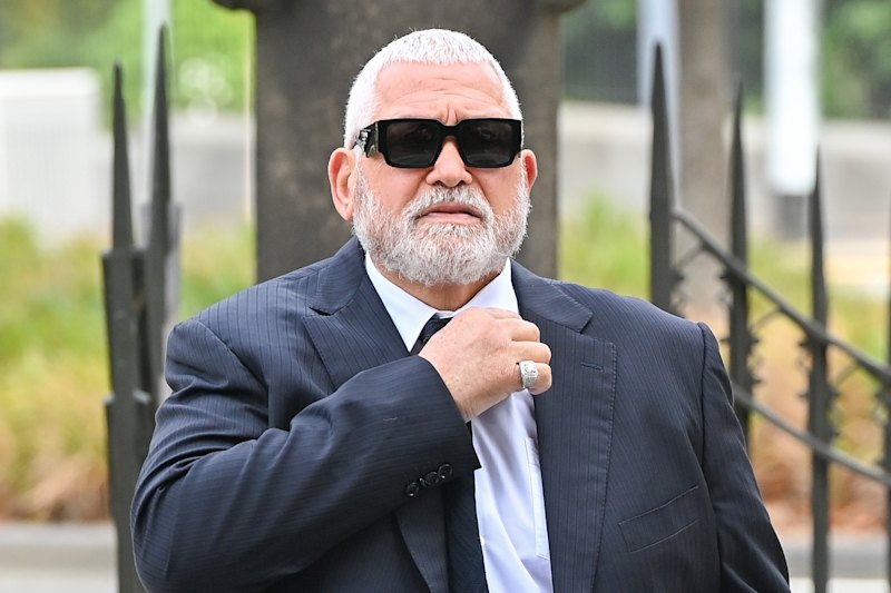 Mick Gatto and wife released from custody after police raid home