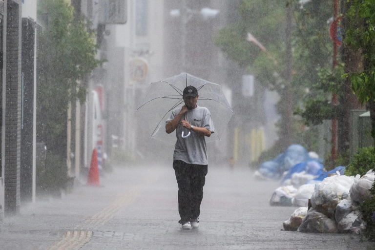 Typhoon slams into Japan triggering flood warnings and travel chaos