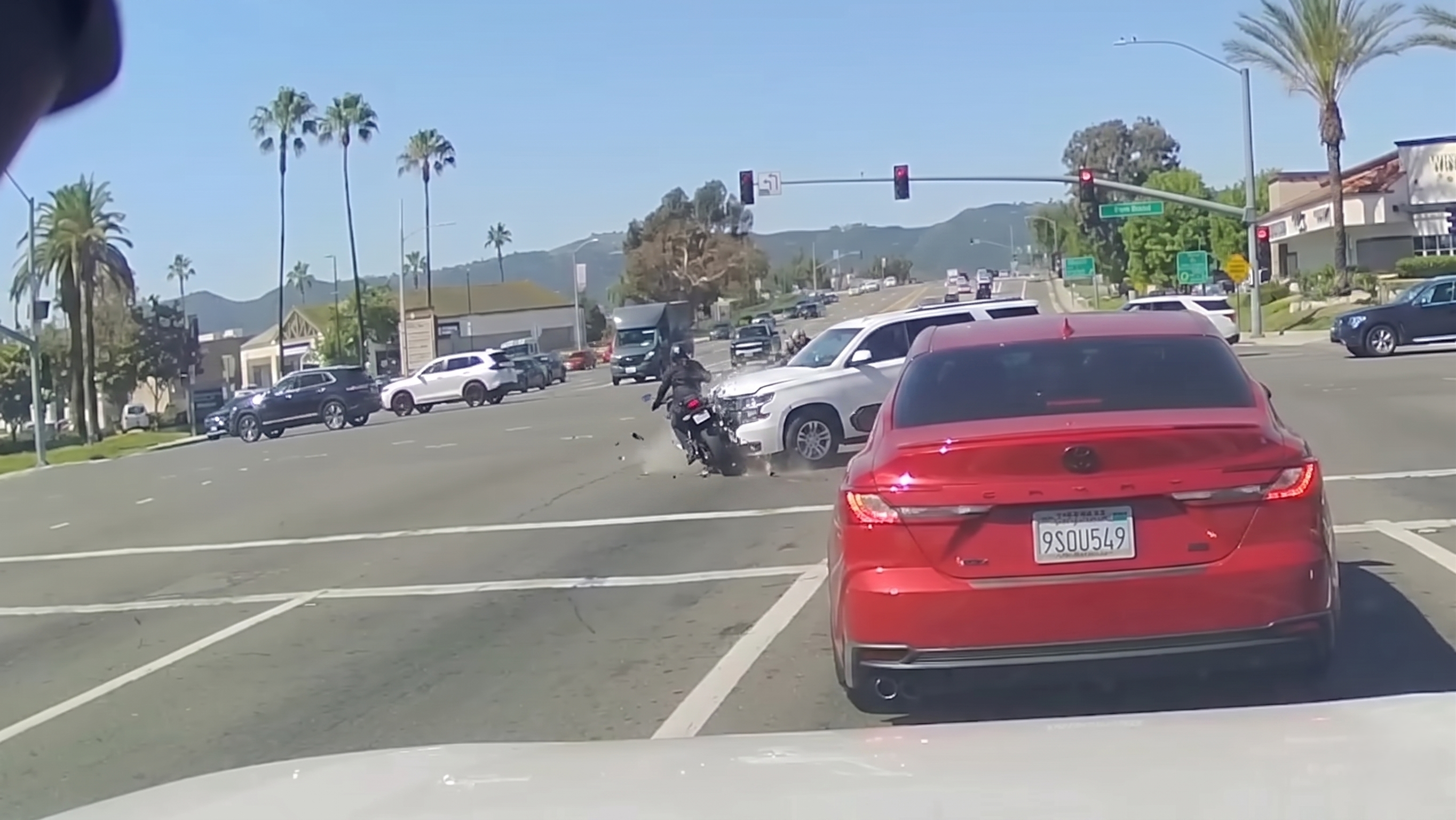 Motorcyclist ignores red light and gets slammed by SUV